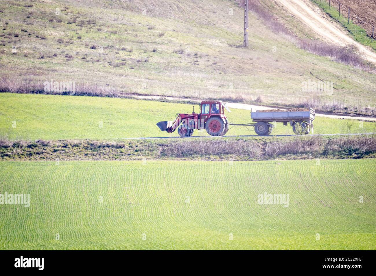 Tractor in a village field Stock Photo - Alamy