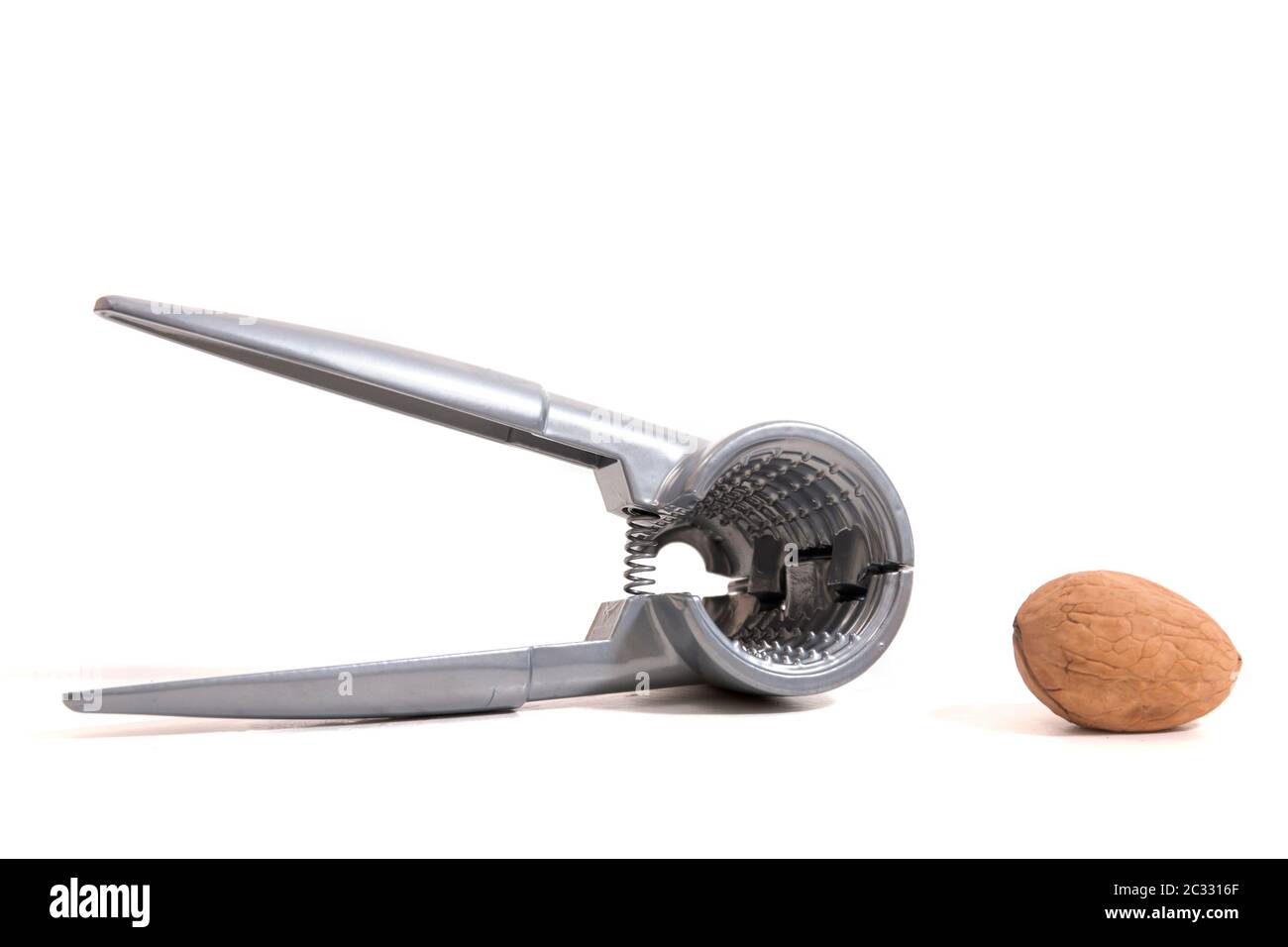 View of a metal tool for cracking nuts isolated on a white background ...