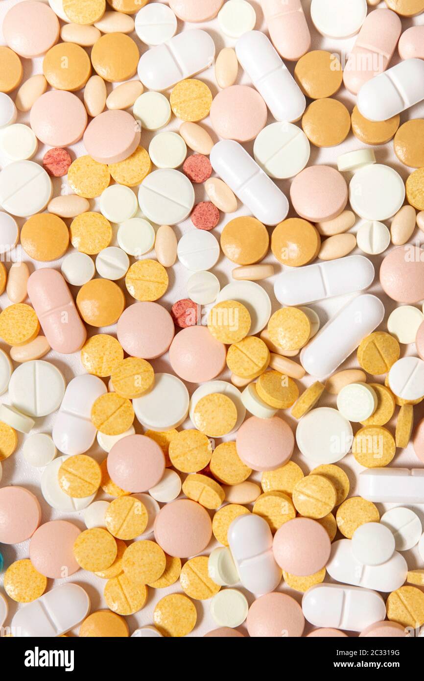 Assorted mix of pills over a white background Stock Photo - Alamy