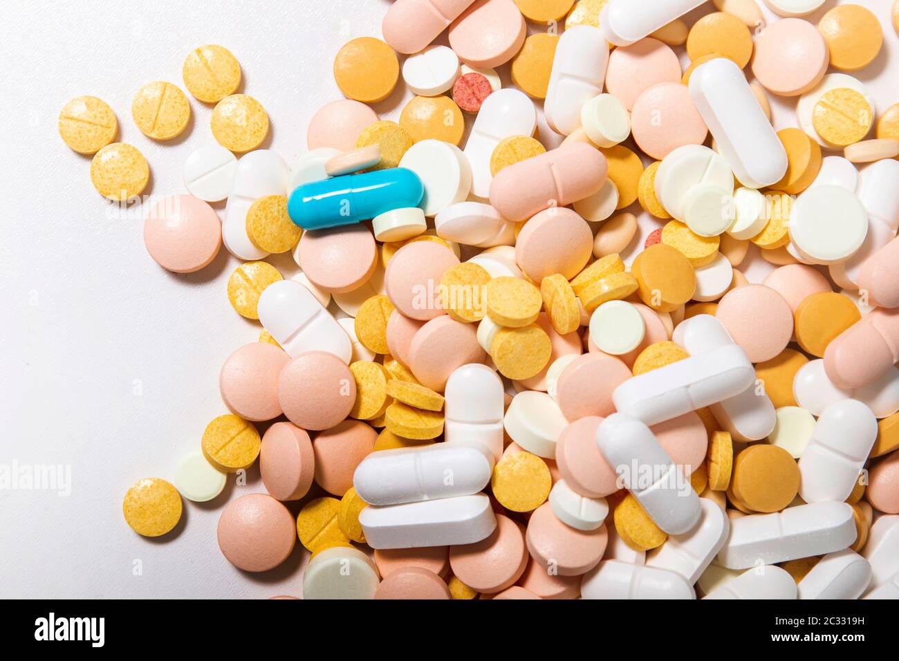 Assorted mix of pills over a white background Stock Photo - Alamy