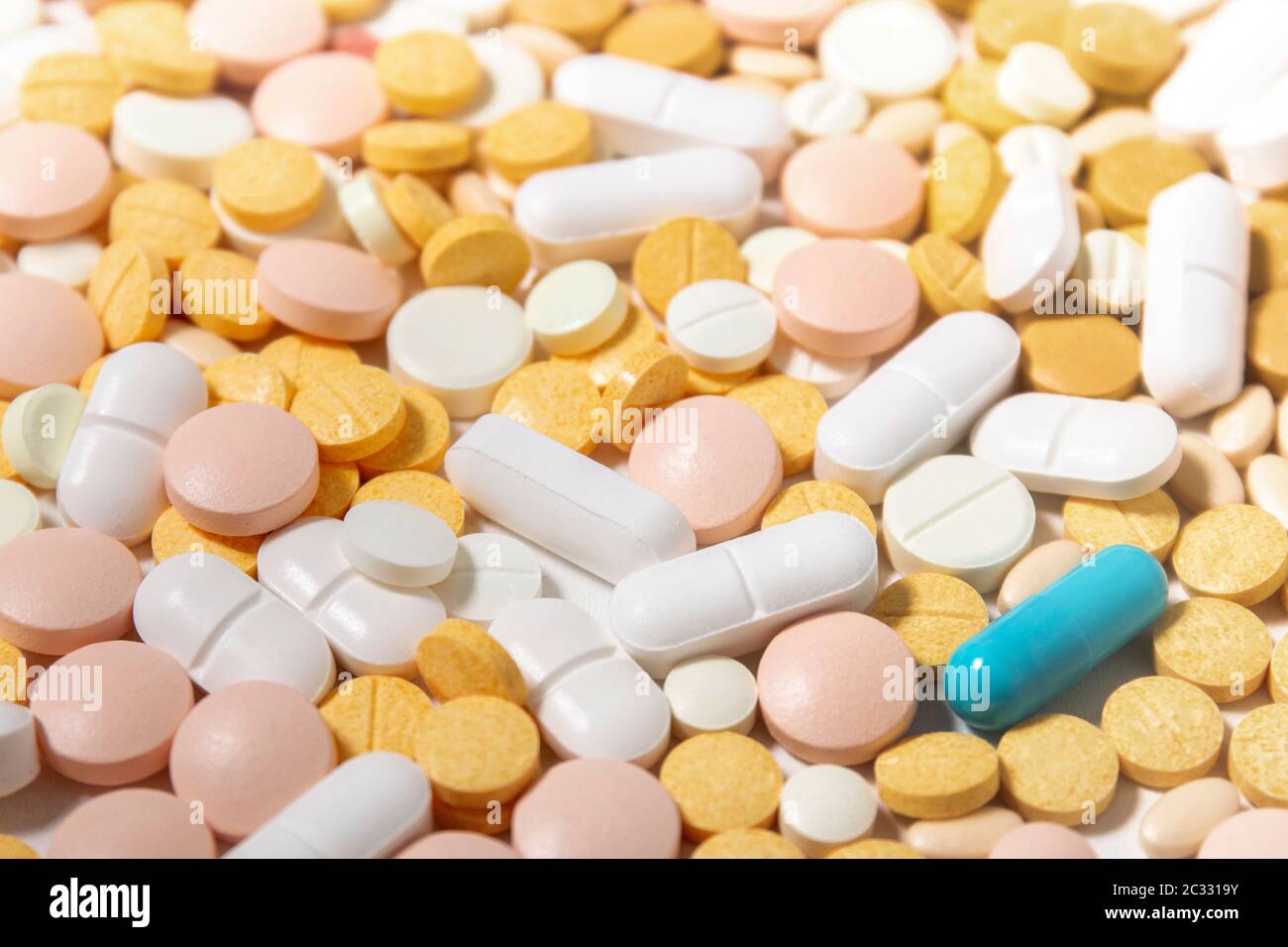 Assorted mix of pills over a white background Stock Photo - Alamy