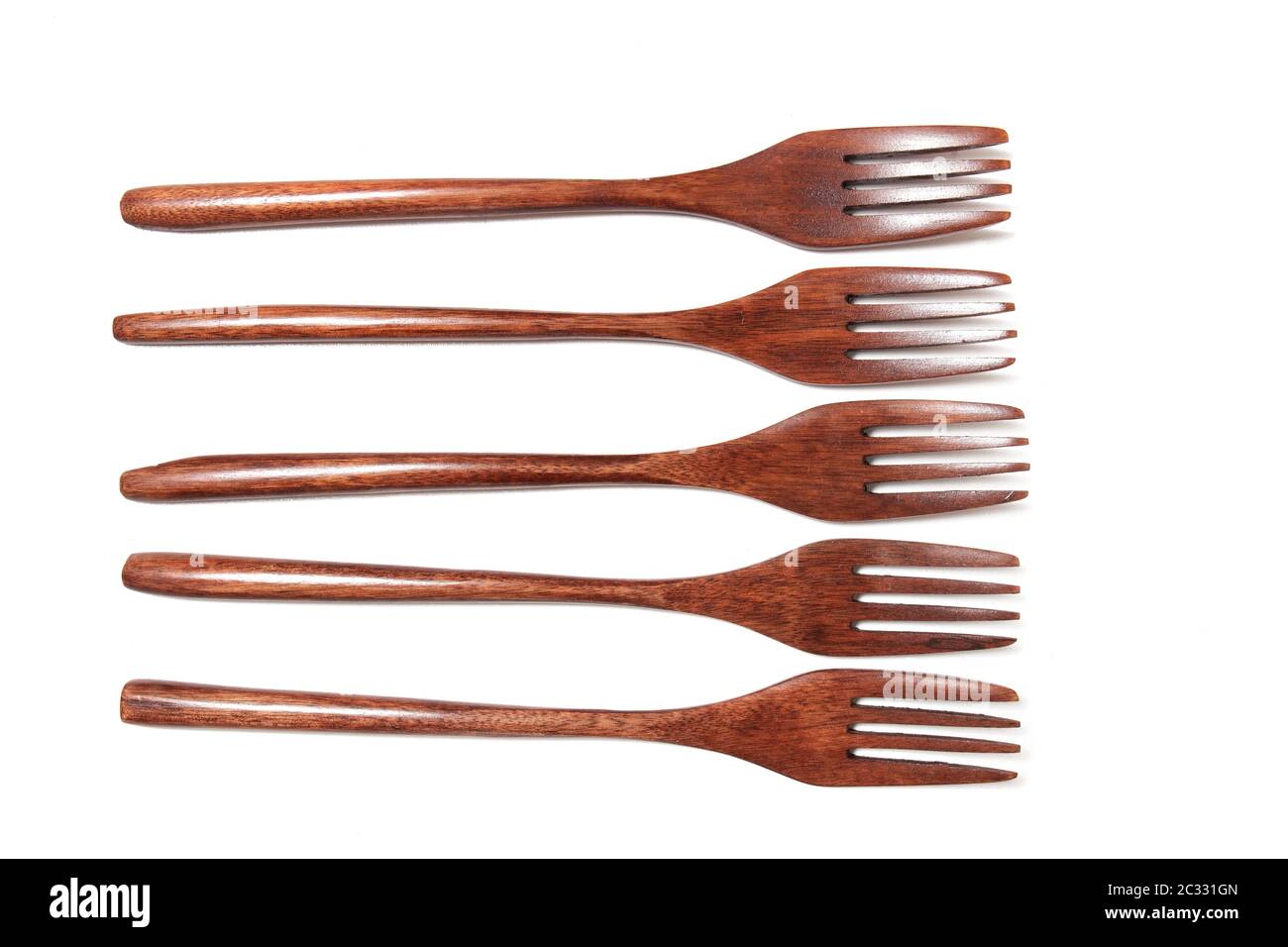 Close view of wooden forks over a white background Stock Photo - Alamy