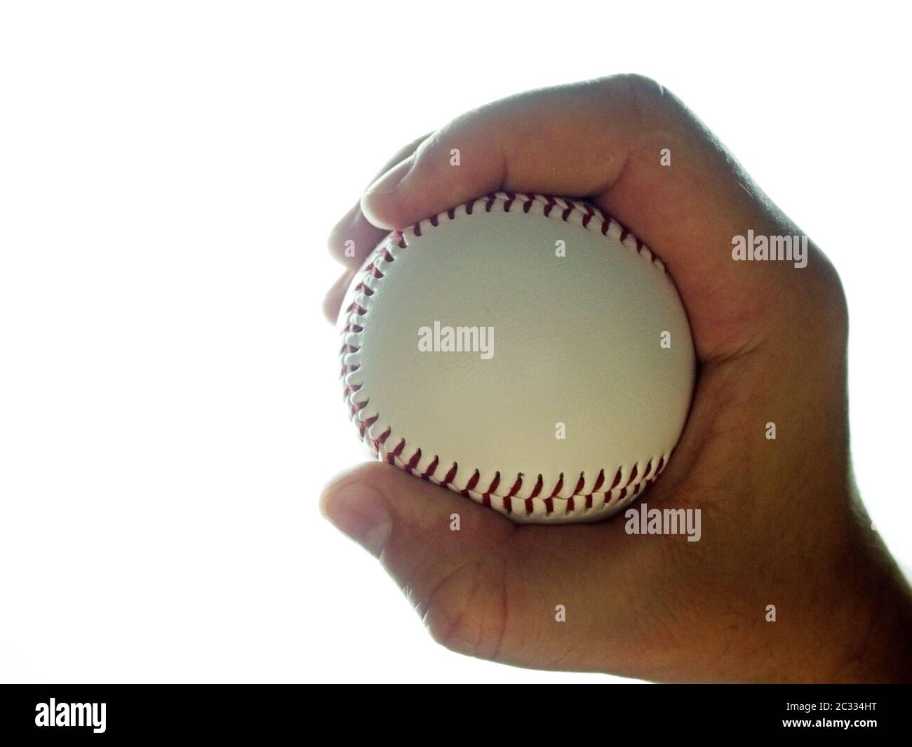 Baseball ball in male hand on white background Stock Photo - Alamy