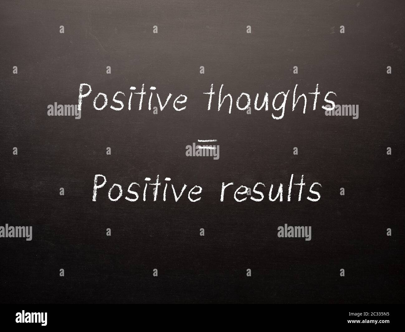 Dark chalkboard with the words positive thoughts give positive results ...