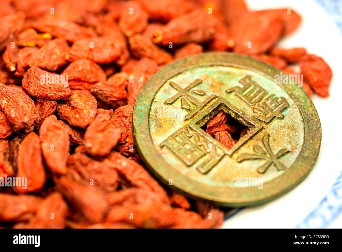 Goji berries, Chinese medicinal fruit with chinese coin Stock Photo - Alamy