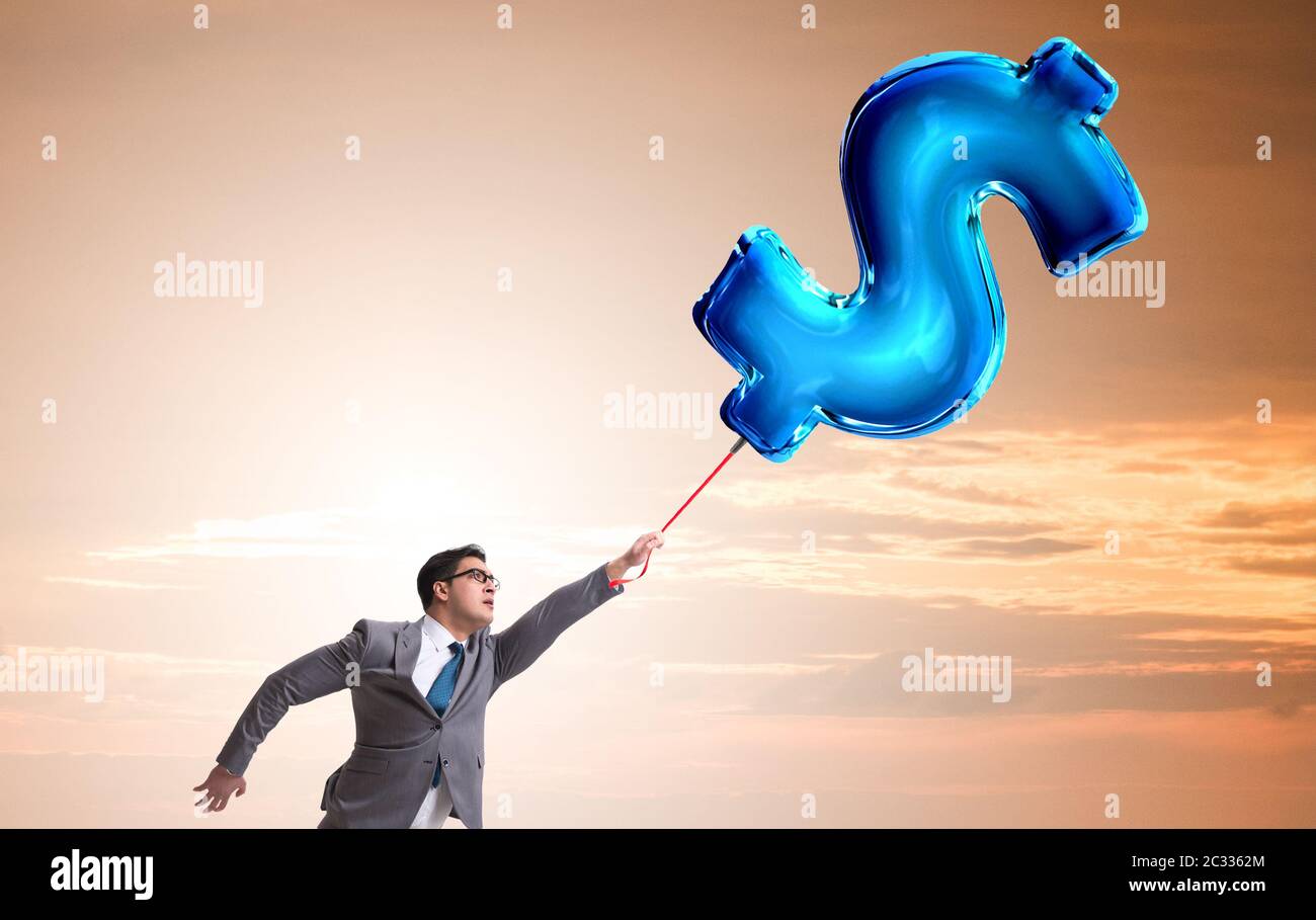 The businessman flying on dollar sign inflatable balloon Stock Photo ...