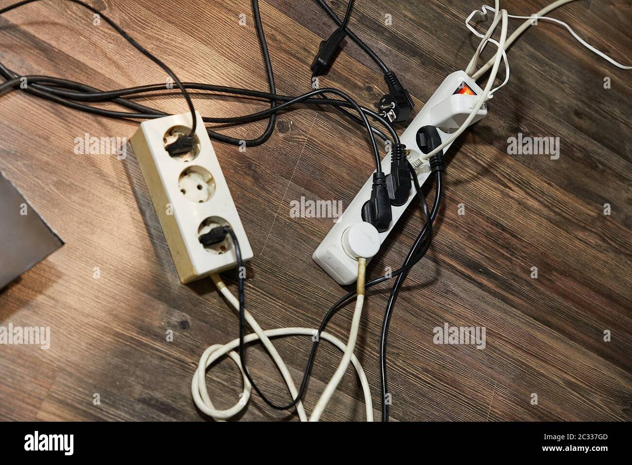 Cables and extension blocks, electreic devices in a mess Stock Photo ...