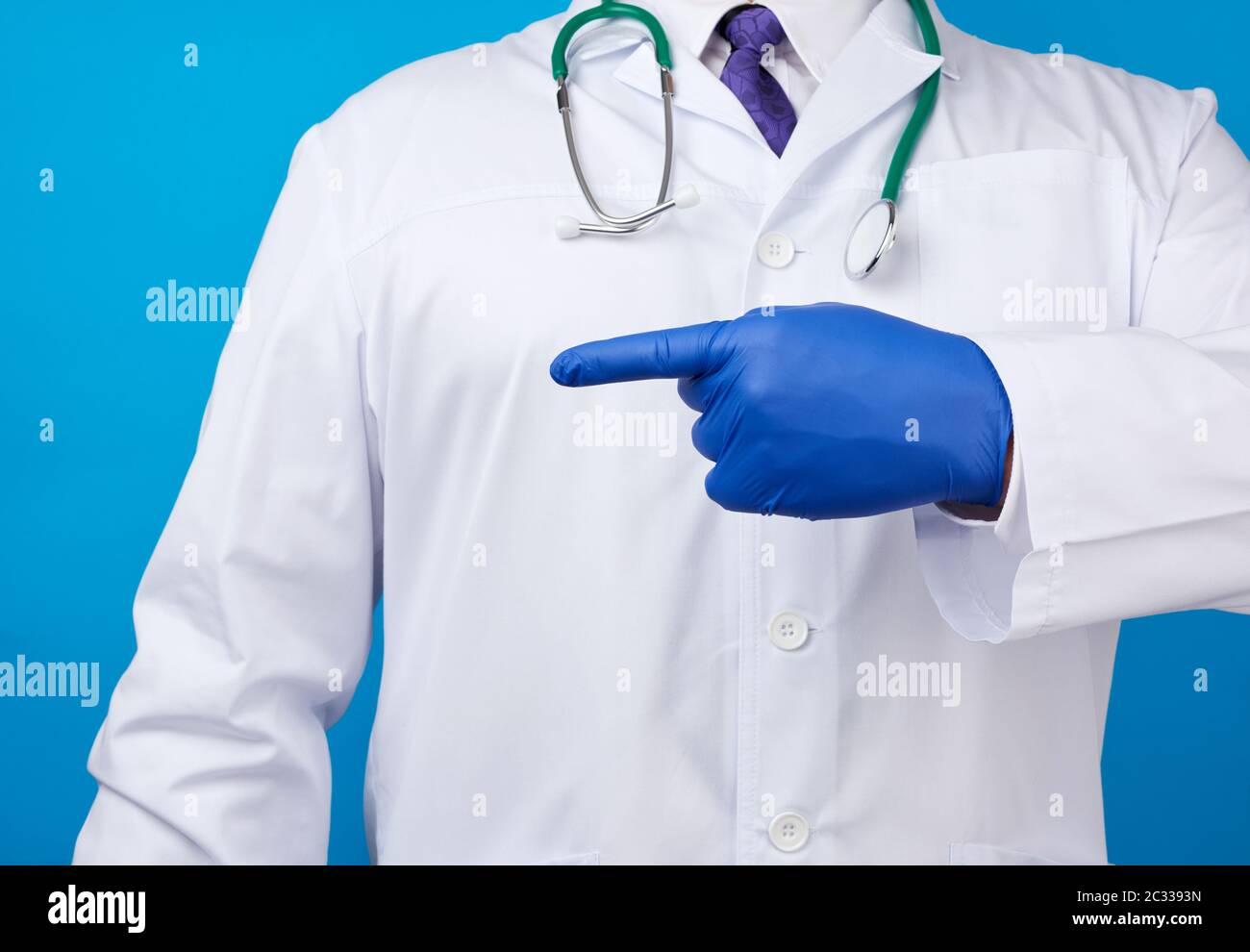 medic man in white coat with buttons, on hands wearing blue sterile ...