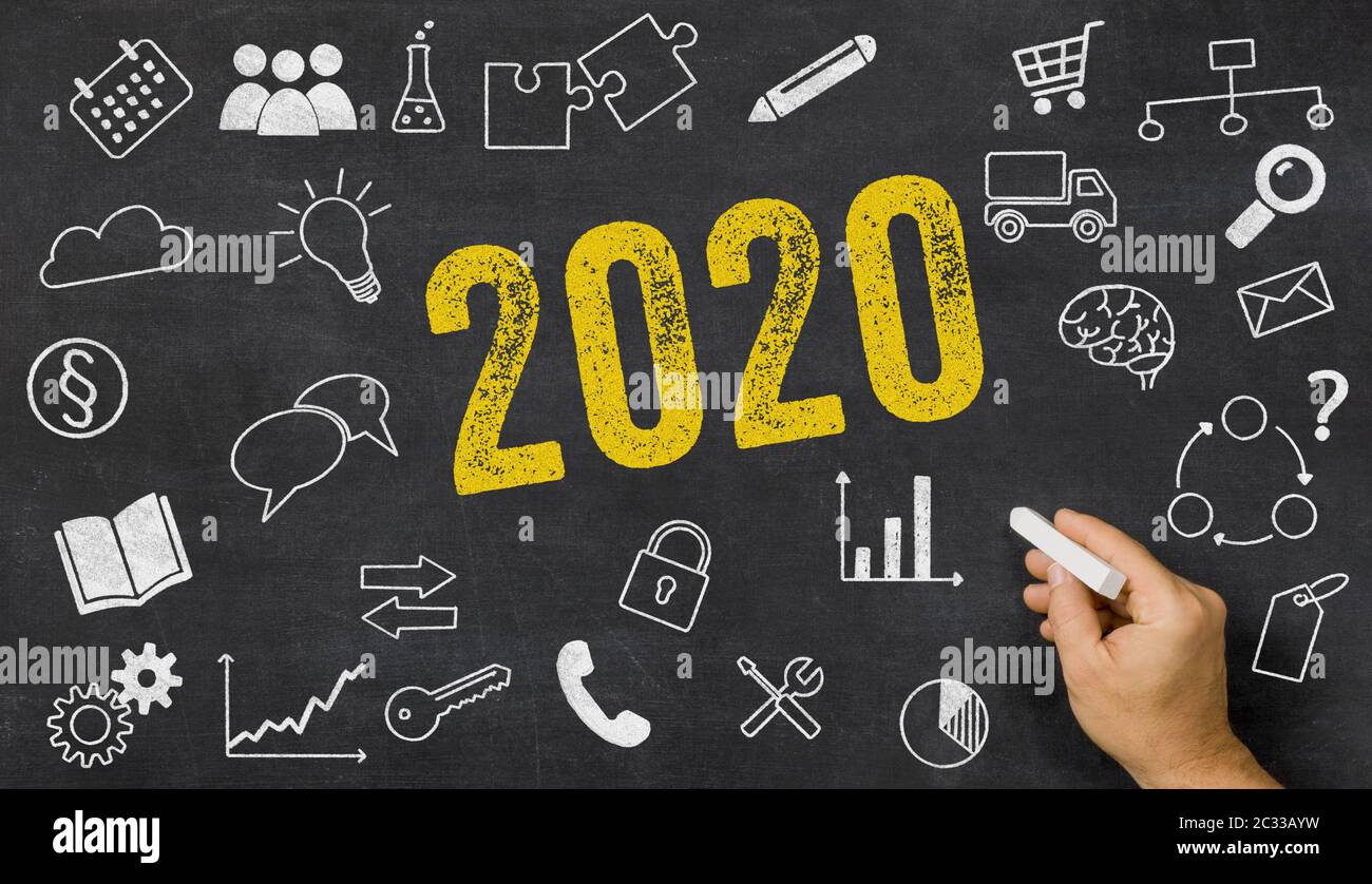 2020 written on a blackboard with icons Stock Photo - Alamy