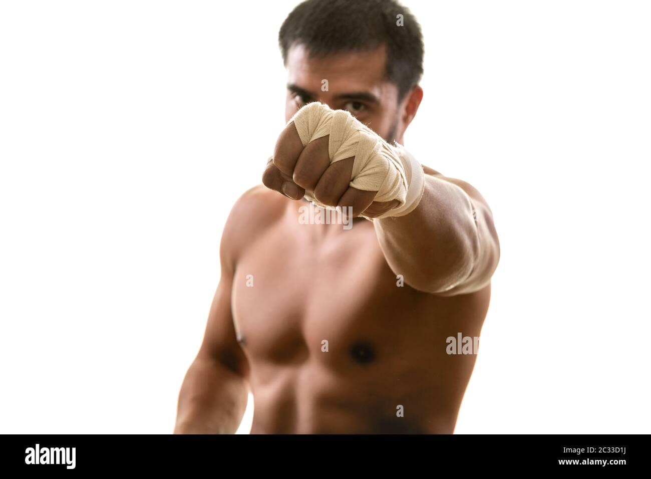 Young muscular strong man with bandaged raised fist, isolated on white ...