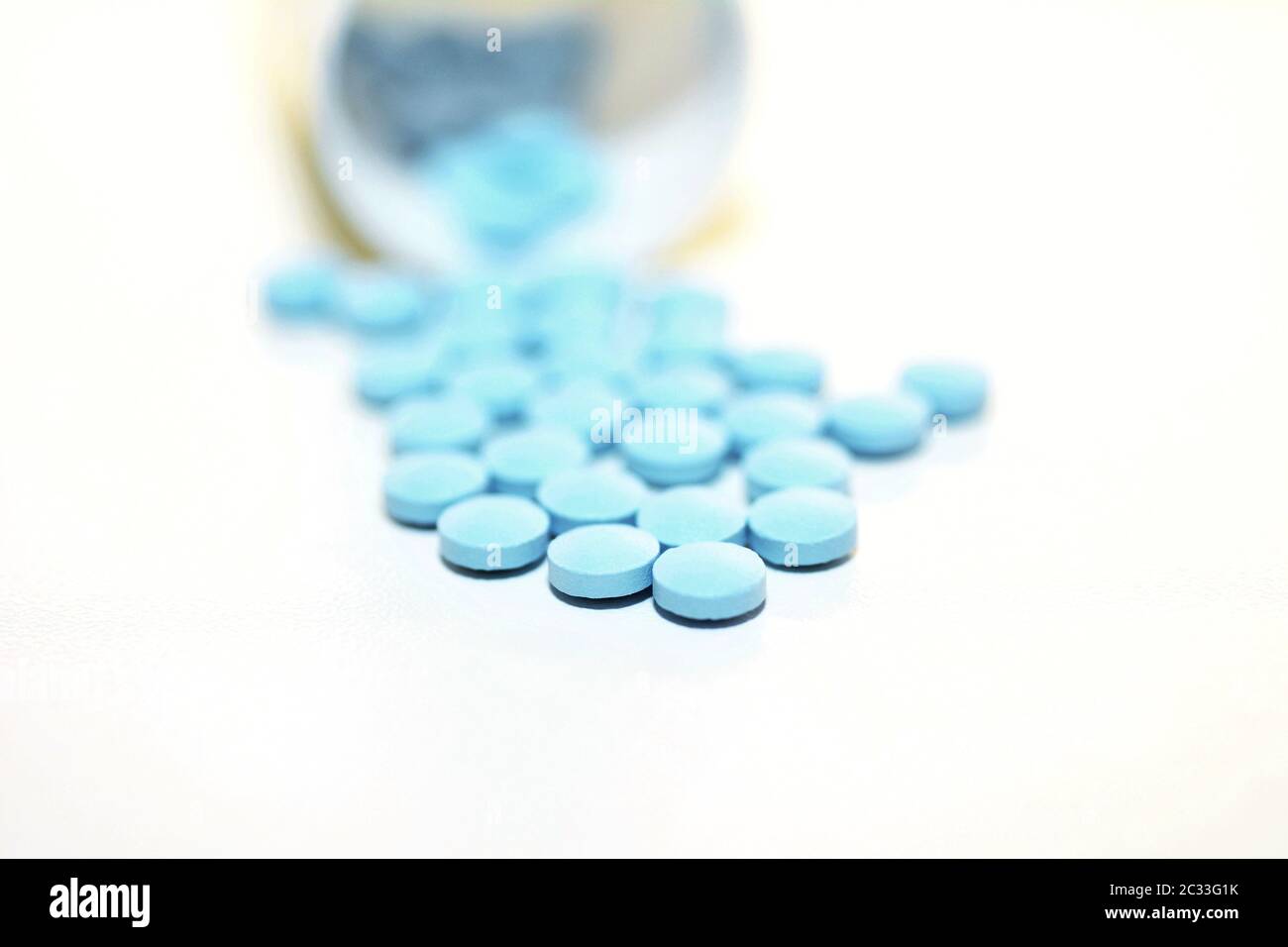 Closeup of a Blue Drug Pills Spilling Out of a Bottle on the White ...