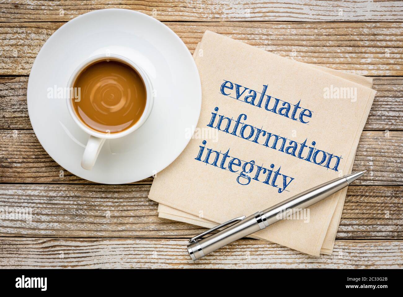 evaluate information integrity reminder - handwriting on a napkin with ...