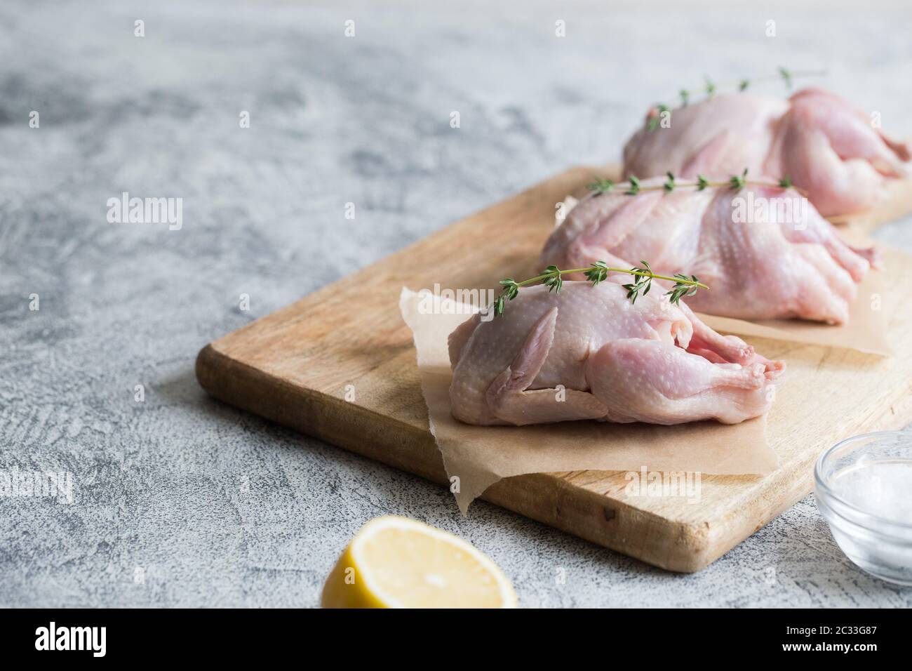 Raw uncooked quail. raw meat quails ready for cooking on a cutting ...