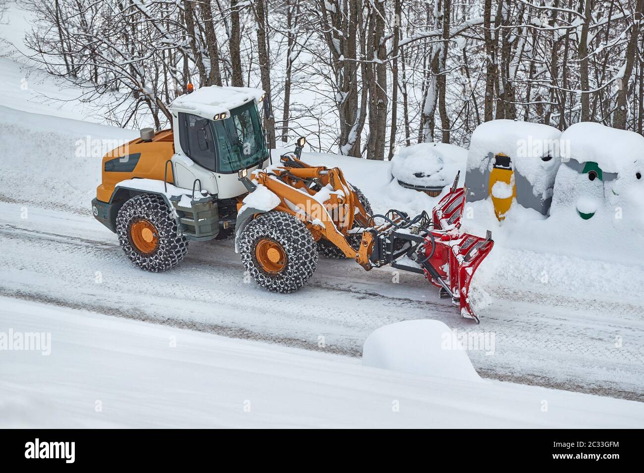 Snowplow machine clearing snow from roads after heavy snowfall in the ...