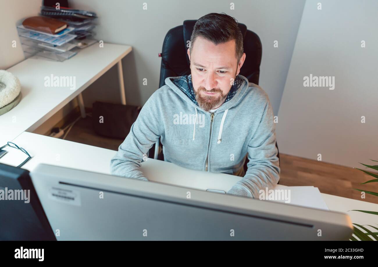 Young man in advertising agency designing project on computer Stock ...