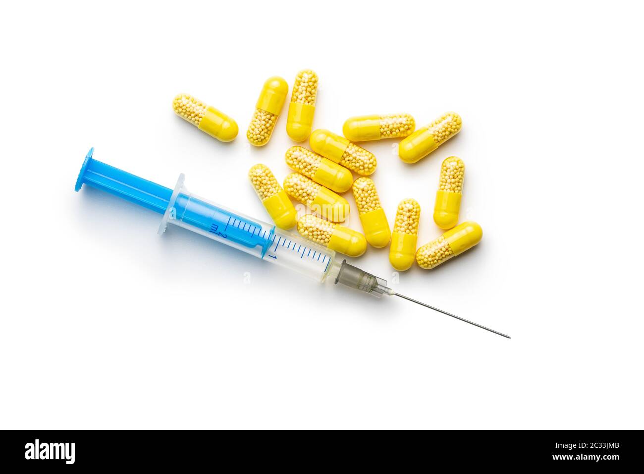 Vitamin capsules. Vitamin C pills and syringe isolated on white ...