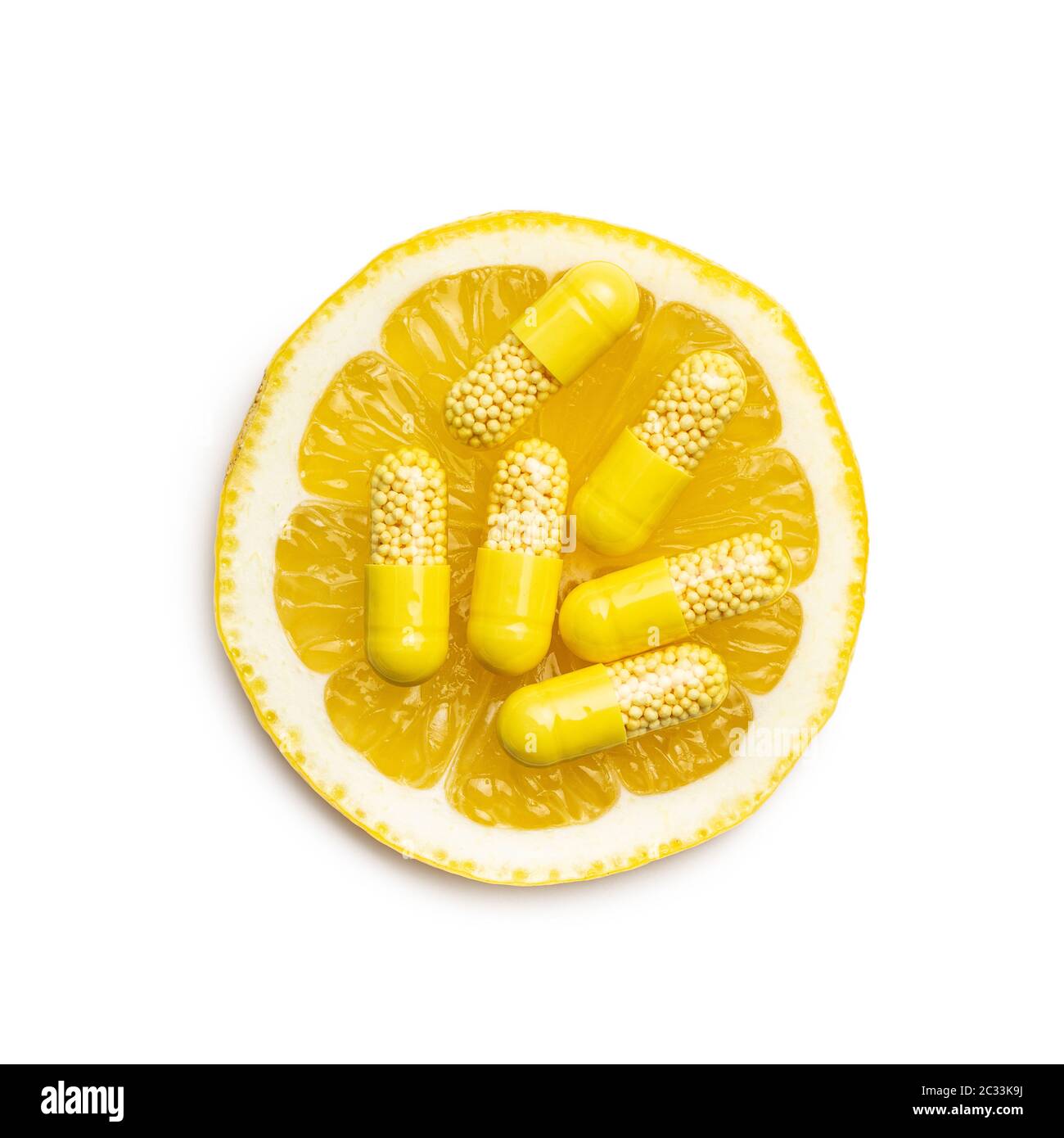 Vitamin capsules. Vitamin C pills and slice of lemon isolated on white ...