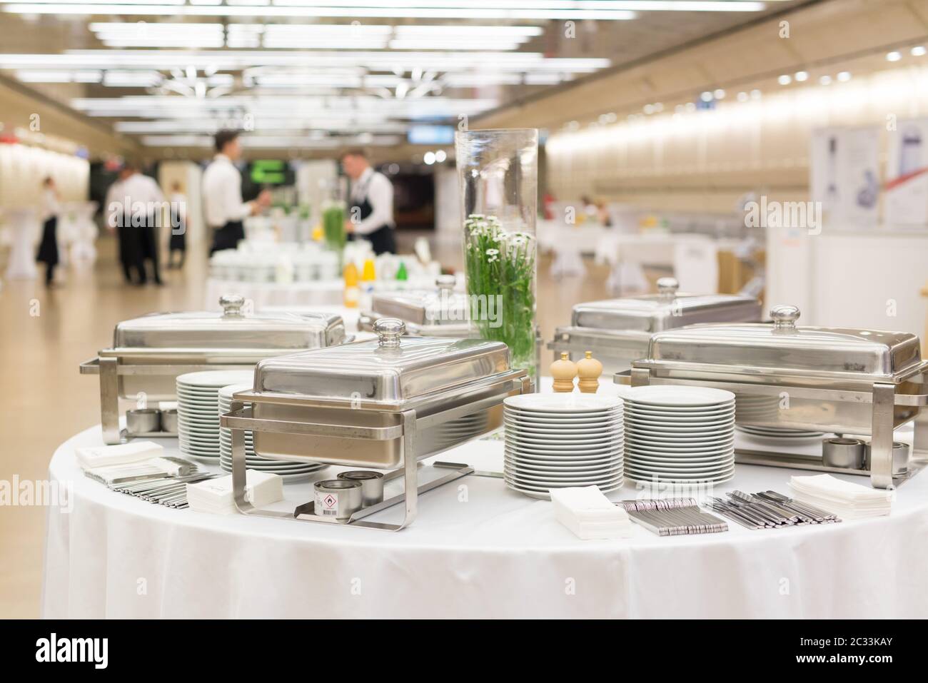Waiters prepare buffet before a coffee break at business conference ...