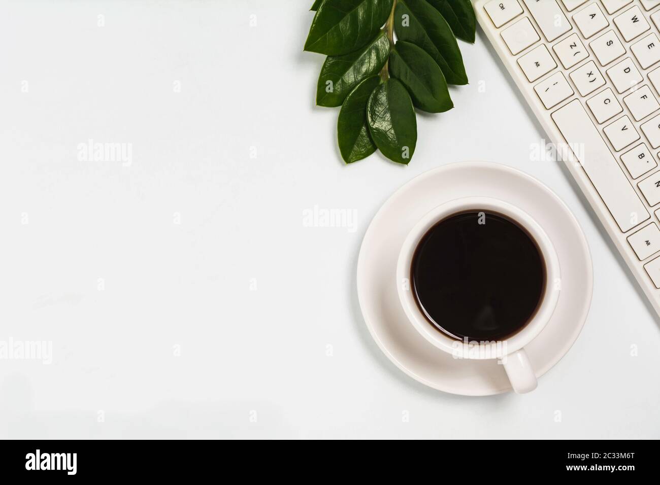 A coffee cup on white office desk with copy space. Business and ...