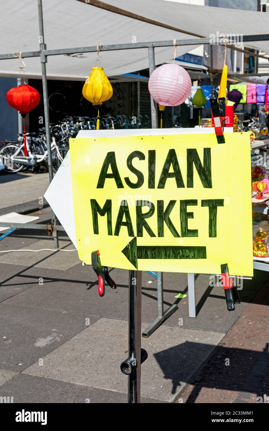 Big Yellow Sign Asian Market Direction Arrow Stock Photo - Alamy