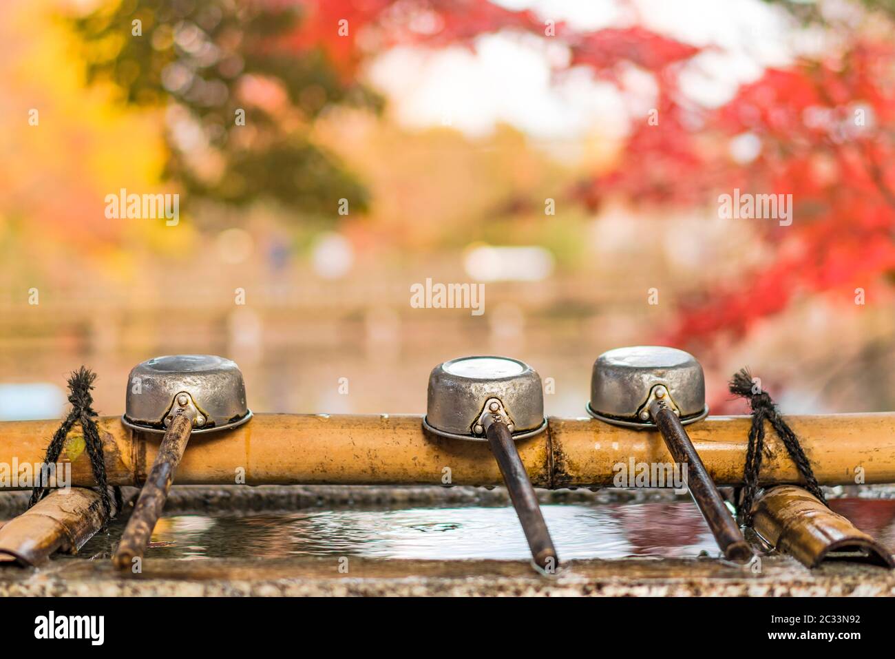 three water ladles on purification basin in the inokashira park of ...