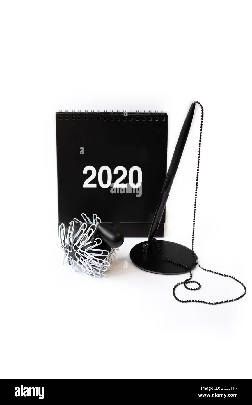 Blank black 2020 paper calendar and pen isolated on white background ...