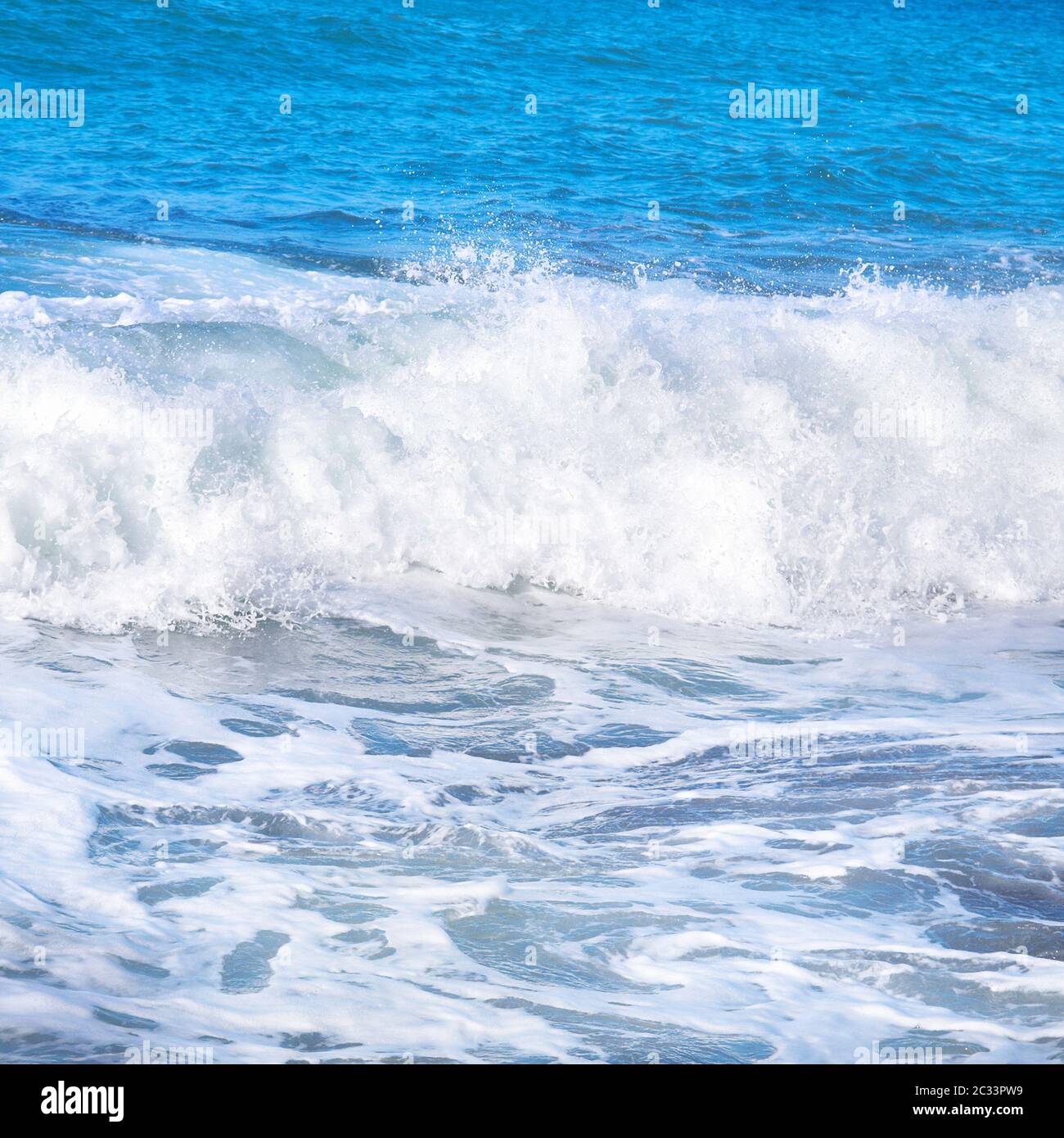 Big wave with sea foam and blue water Stock Photo - Alamy