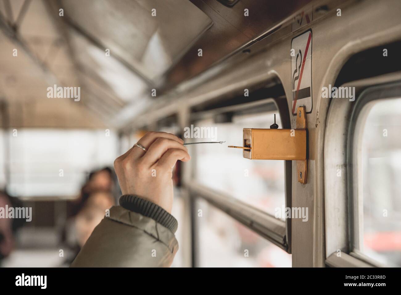 marking the ticket in the tram using a perforator Stock Photo - Alamy