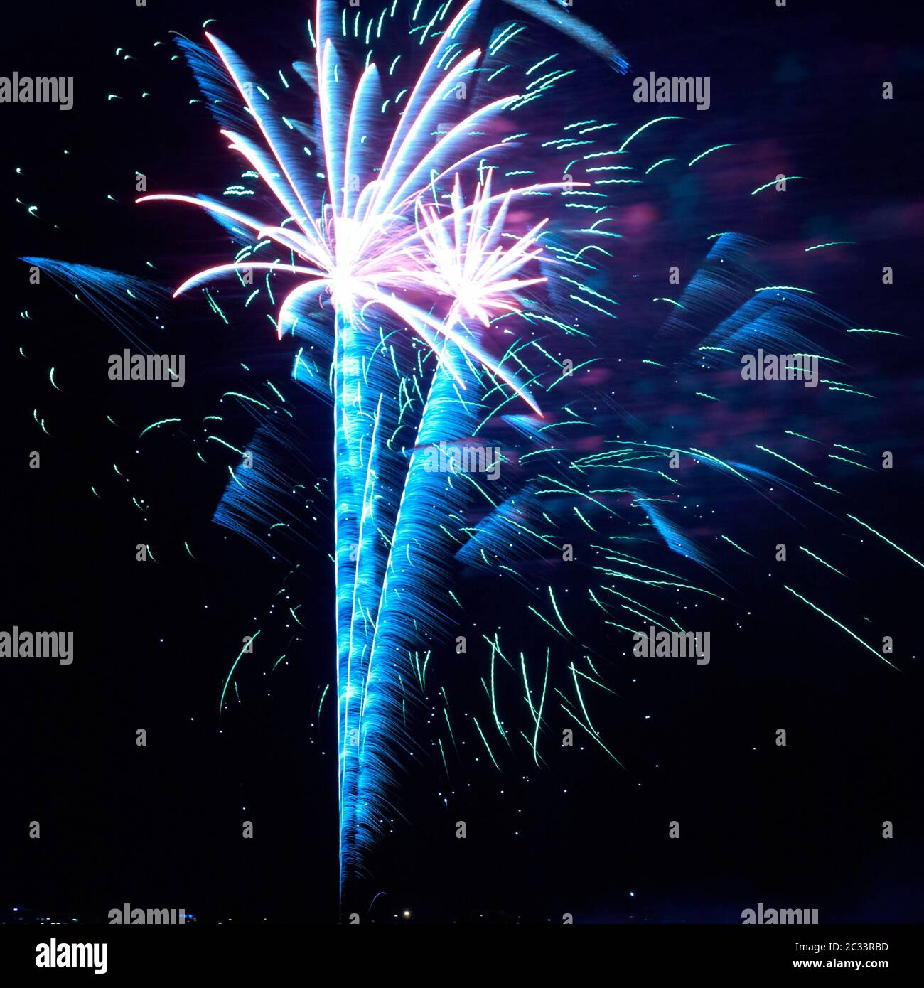 Blue and red colorful holiday fireworks on the black sky background ...