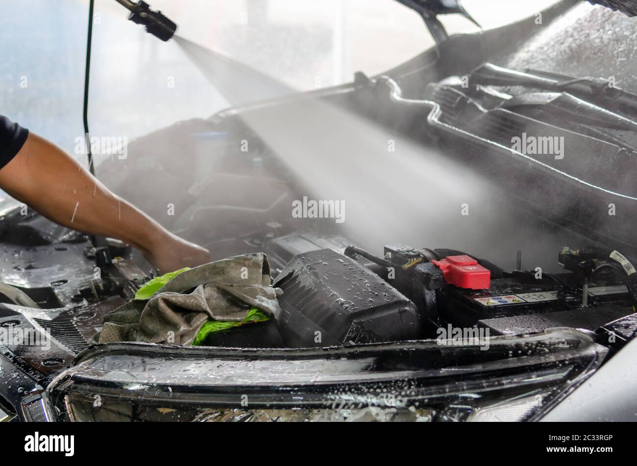 High pressure water gun. Car engine wash at the station Stock Photo - Alamy