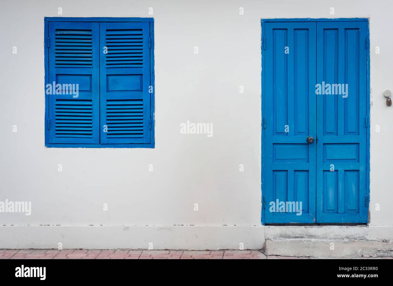 White wall with closed shatter window and door Stock Photo - Alamy