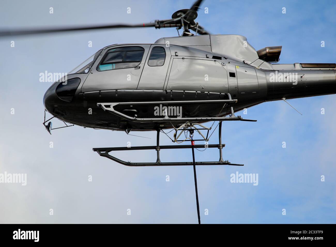 A cargo helicopter on the railway construction site KÃ¶then, mast ...