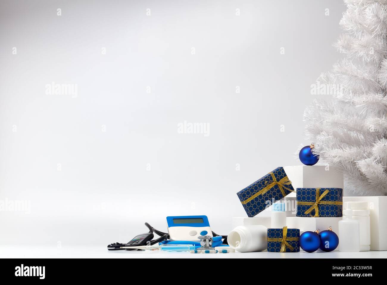 Stethoscope, medical devices, white fir tree, gift boxes and Christmas ...