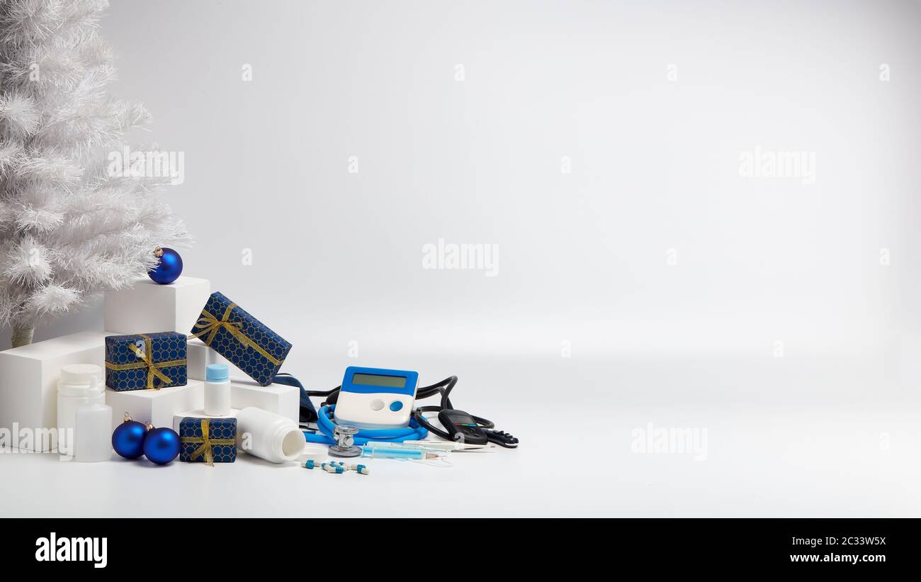 Stethoscope, medical devices, white fir tree, gift boxes and Christmas ...