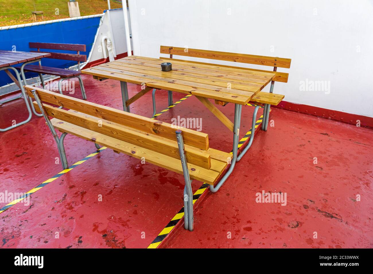 Wooden Table With Bench Seating at Ship Deck Stock Photo - Alamy