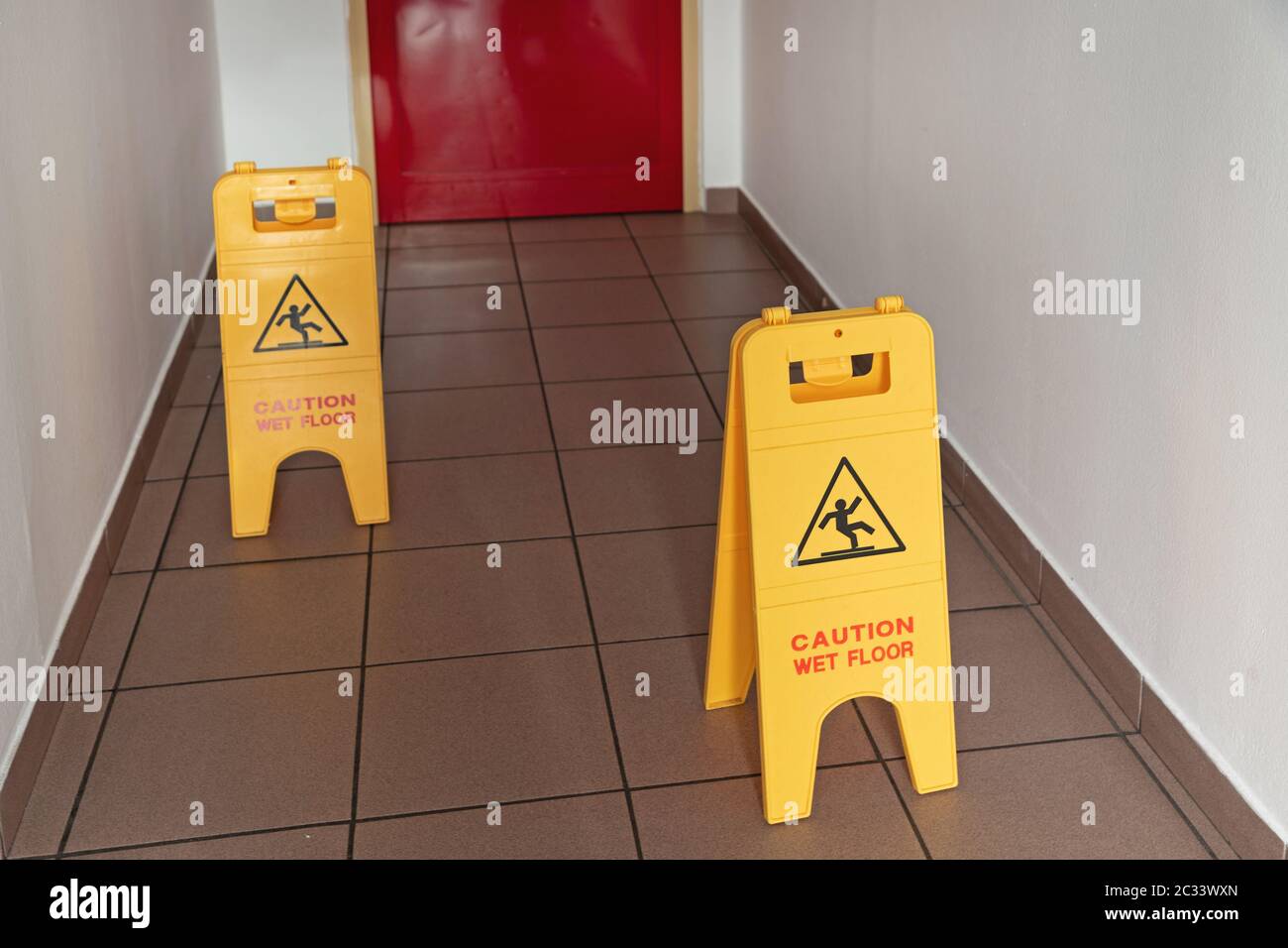 Two Yellow Plastic Warning Sign Caution Wet Floor Stock Photo - Alamy