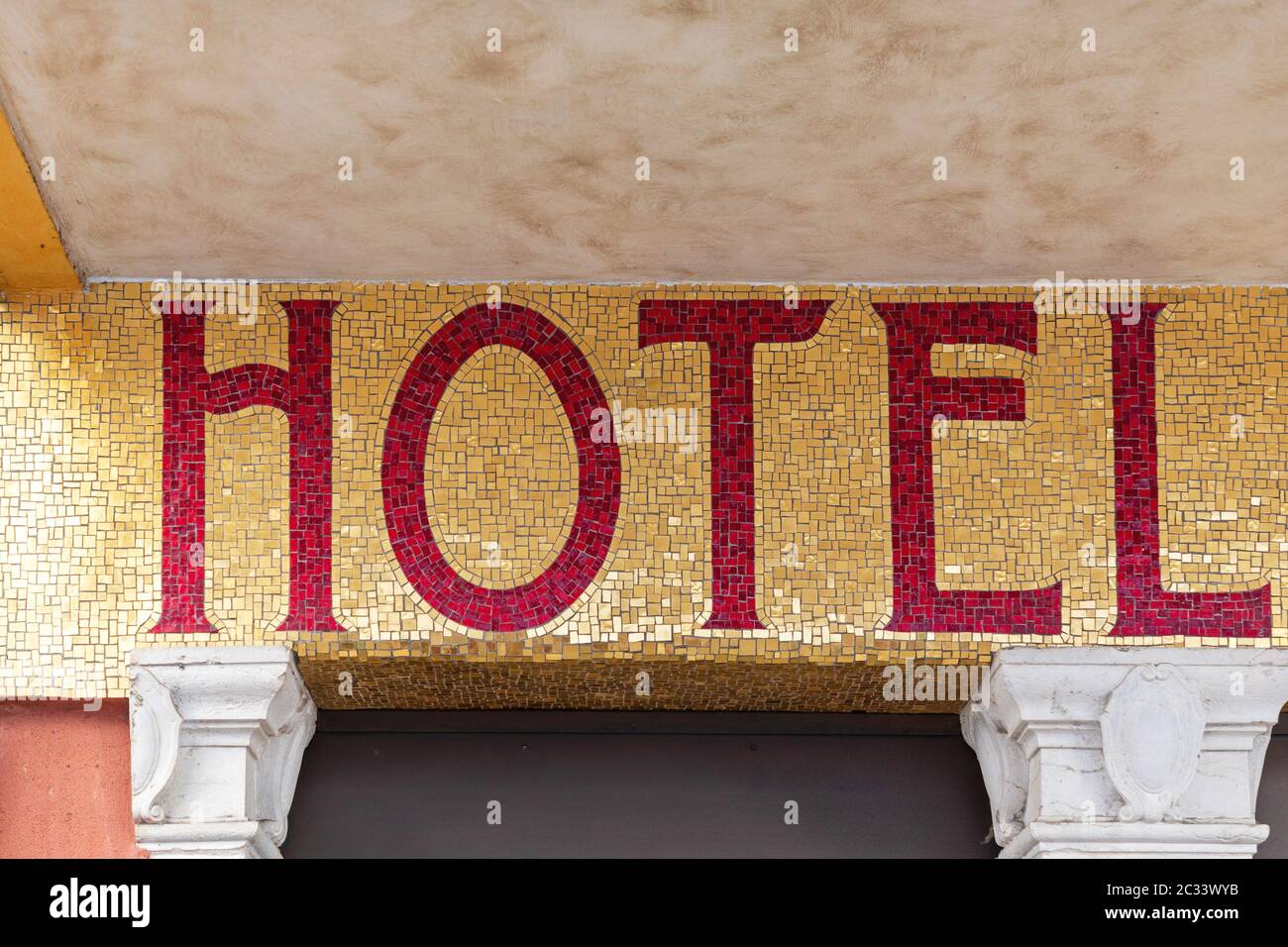 Old Style Hotel Letters Sign at Gold Tiles Mosaic Stock Photo - Alamy