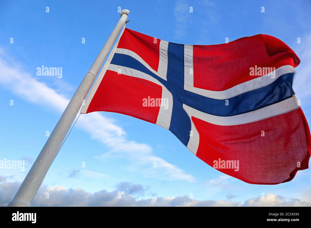 Norwegian Flag Flying at Flagpole Over bLue Sky Stock Photo - Alamy