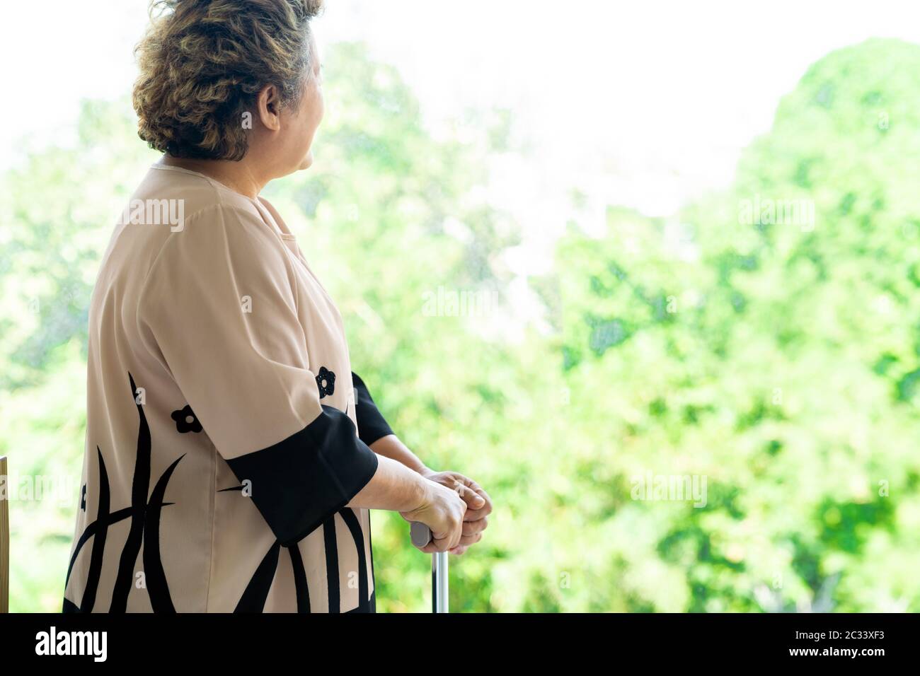 Elderly senior female using walking stick or walking cane staff ...