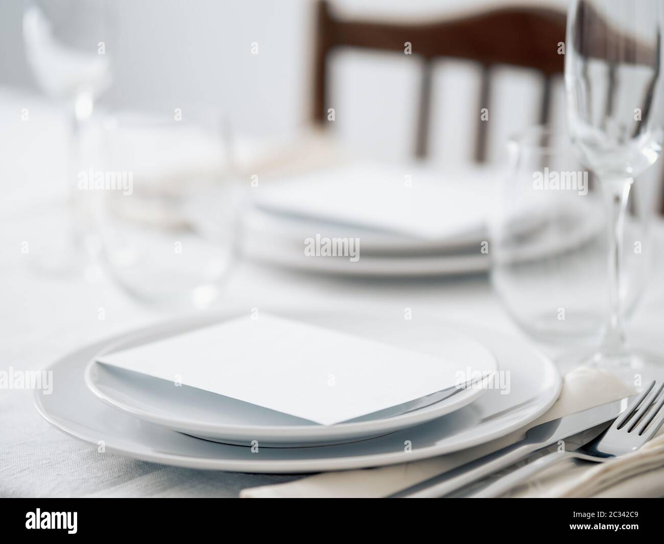 Beautiful table setting in white colors. Empty white plates. Set table ...