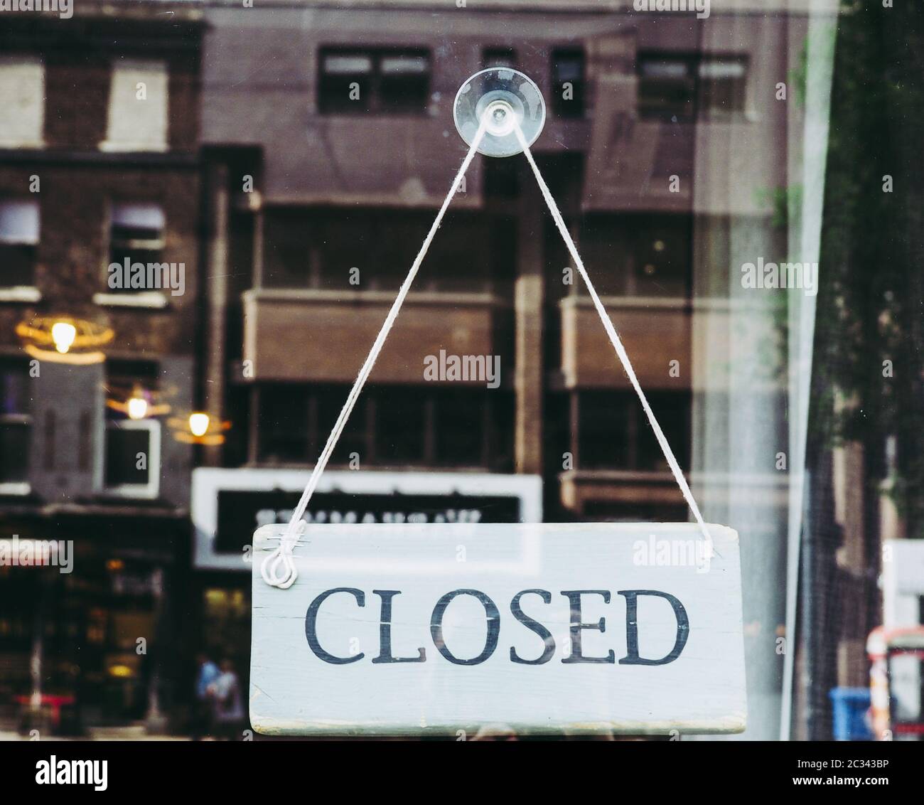 Closed sign in a shop window with reflections Stock Photo - Alamy