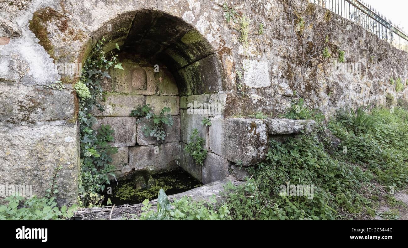 old stone water source in portugal - ancient well in the countryside ...