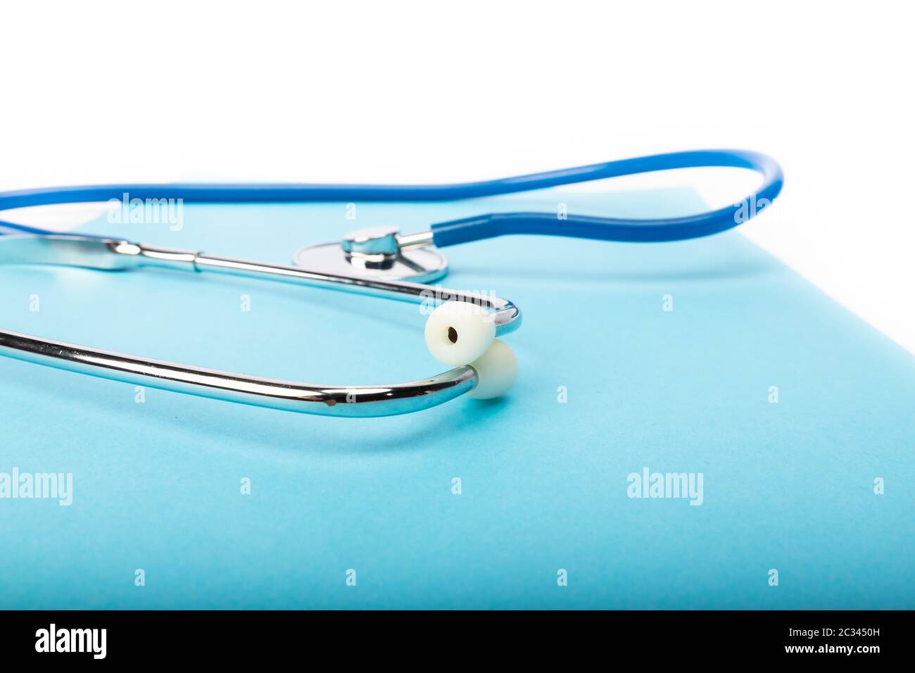 medical record and blue stethoscope close-up on white background in ...