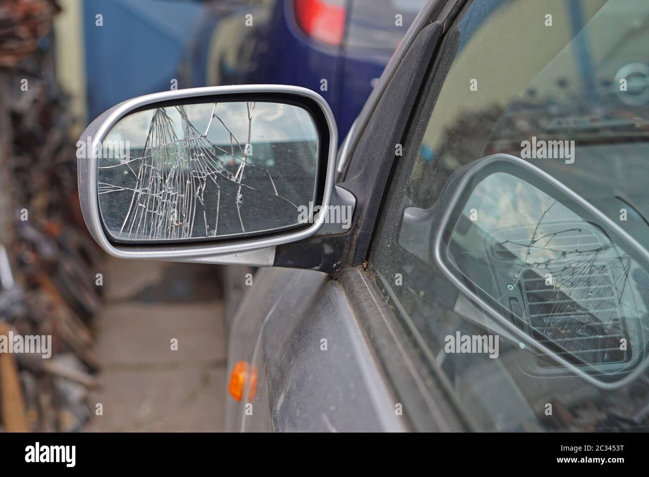 Broken glass at car side mirror damage Stock Photo - Alamy