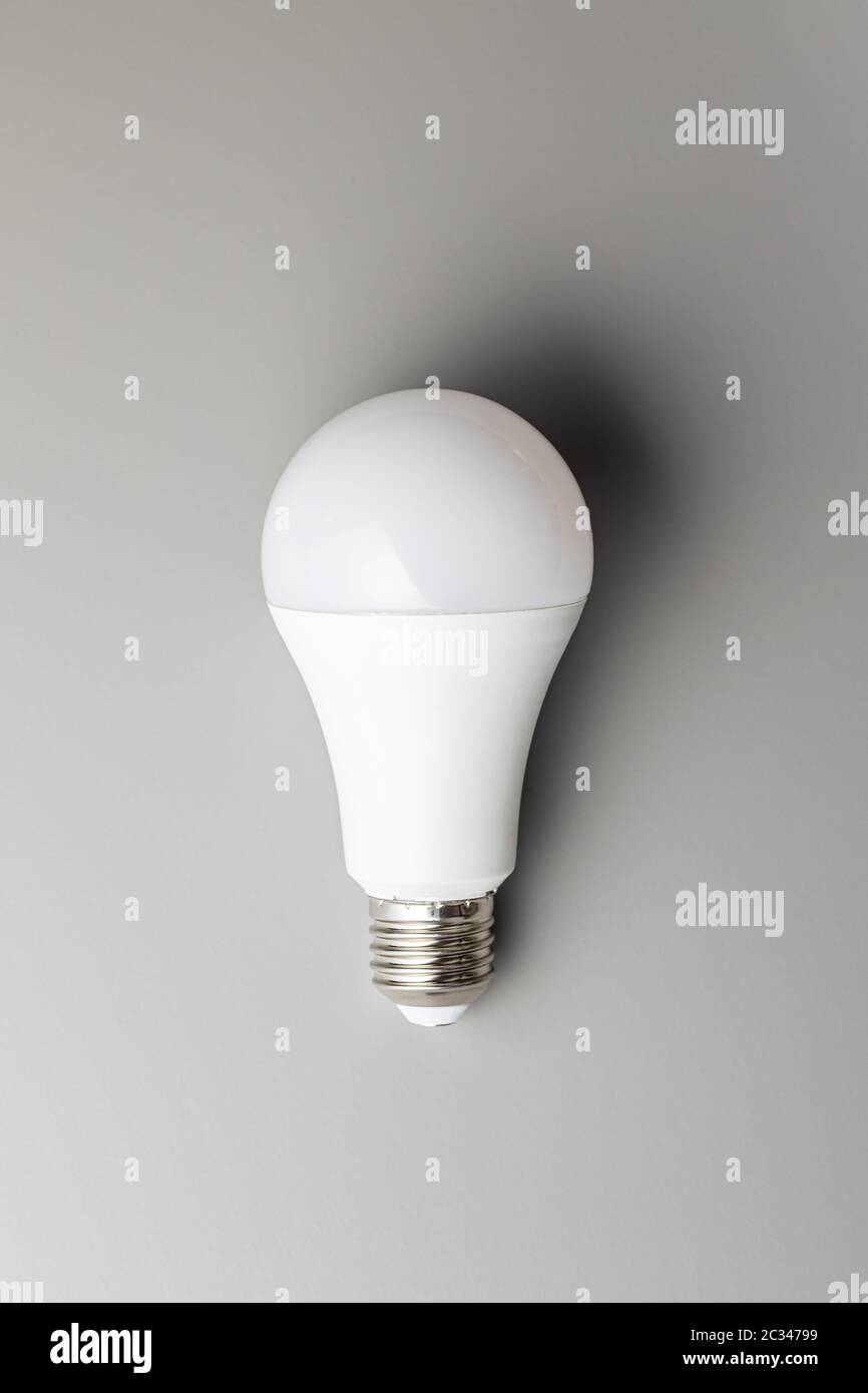 Energy saving light bulb on gray background. LED light bulb. Top view ...