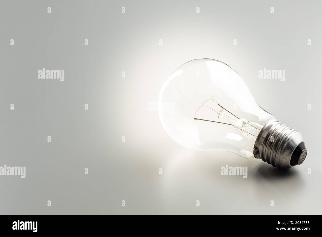 Classic light bulb on gray background Stock Photo - Alamy