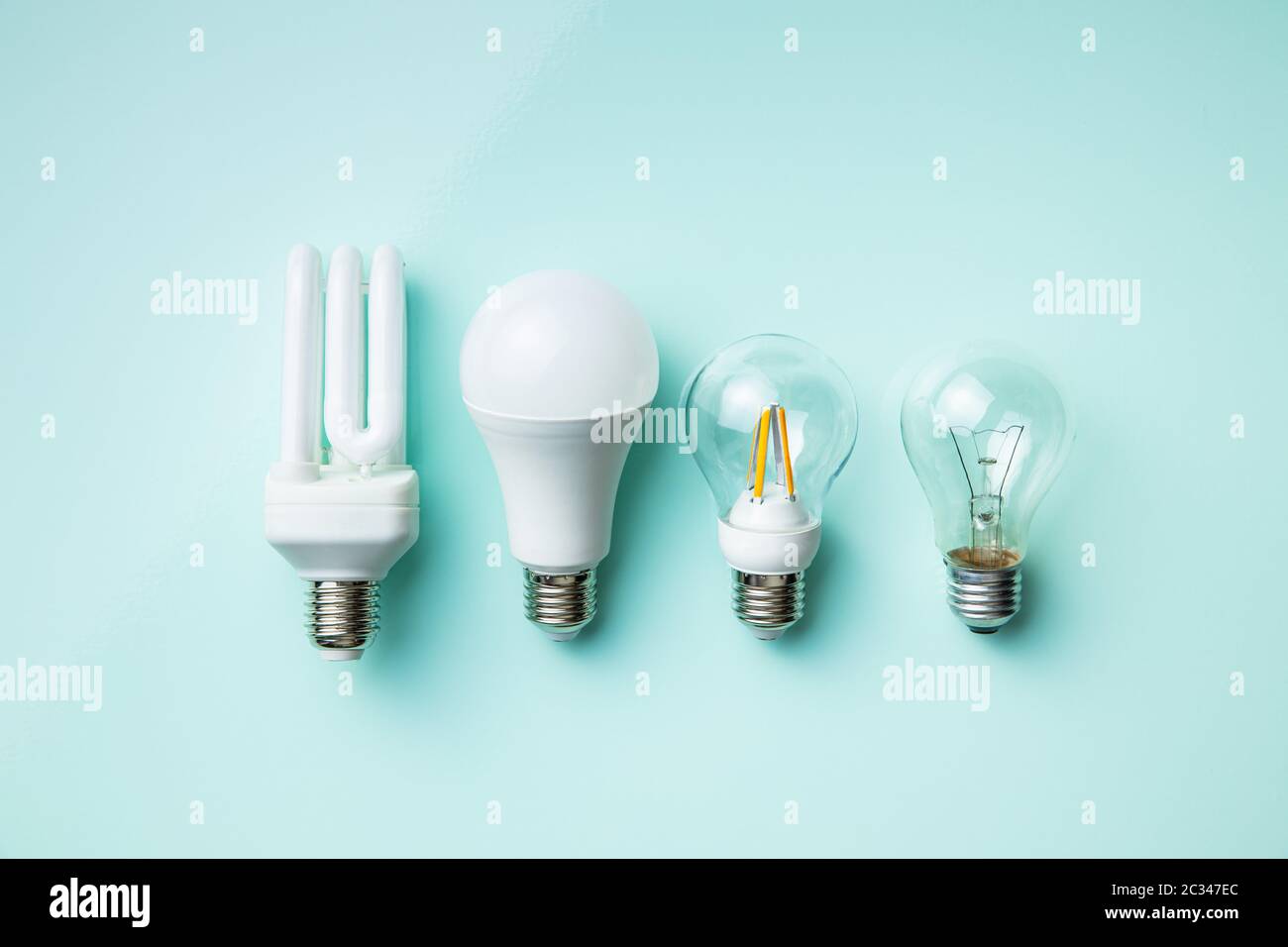 Energy saving and classic light bulbs on colorful background. Top view ...