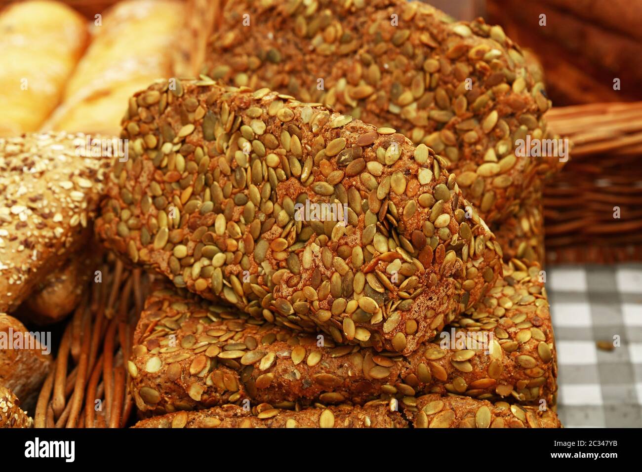 Close up selection of assorted fresh bread loaves on retail display of ...