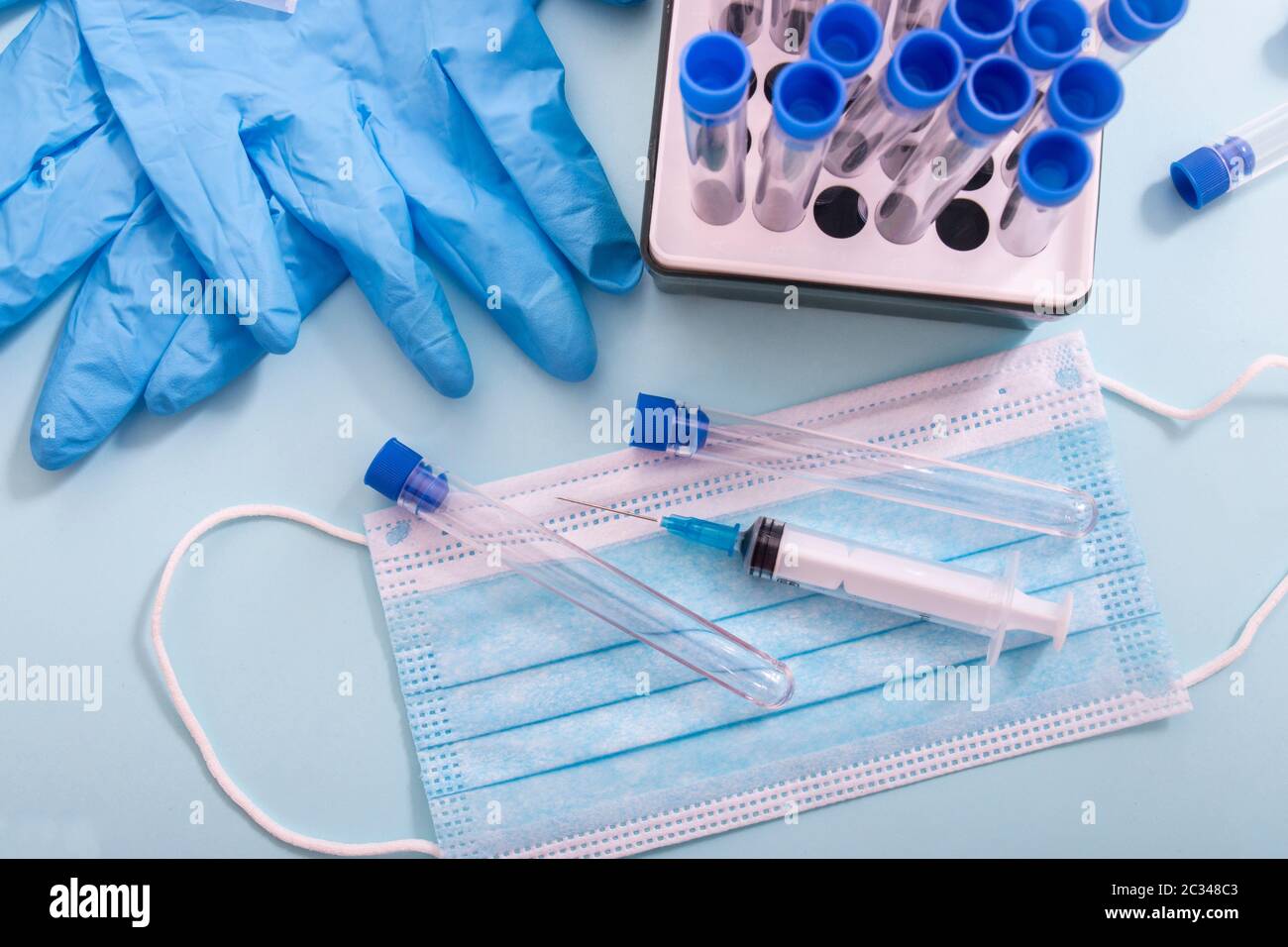 Several laboratory objects including protective mask, vial rack ...