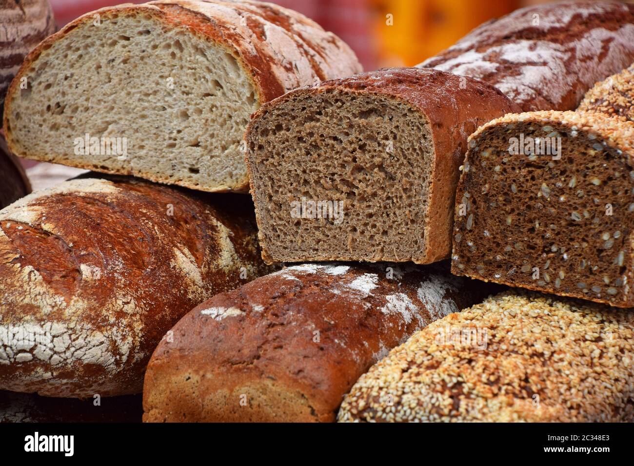 Close up selection of assorted fresh bread loaves on retail display of ...